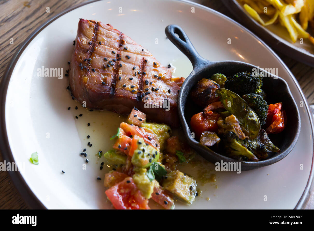 Healthy dinner, braised tuna fillet with grilled vegetables and salad ...