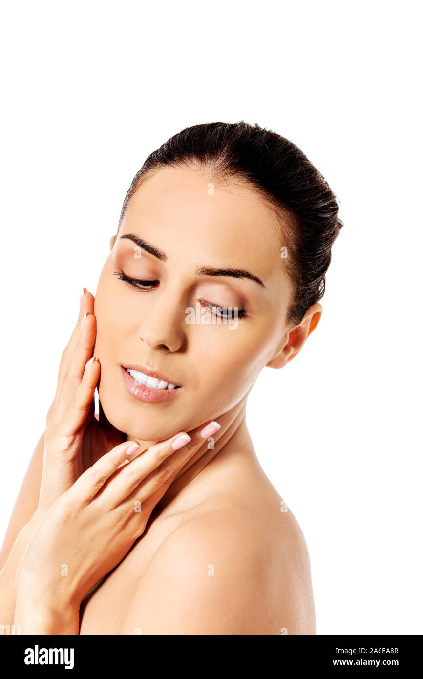 Beautidul woman touching her face and feeling bliss. Skin treatment and ...