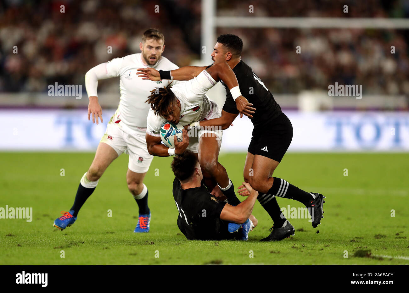 England's Anthony Watson is tackled by New Zealand's George Bridge ...