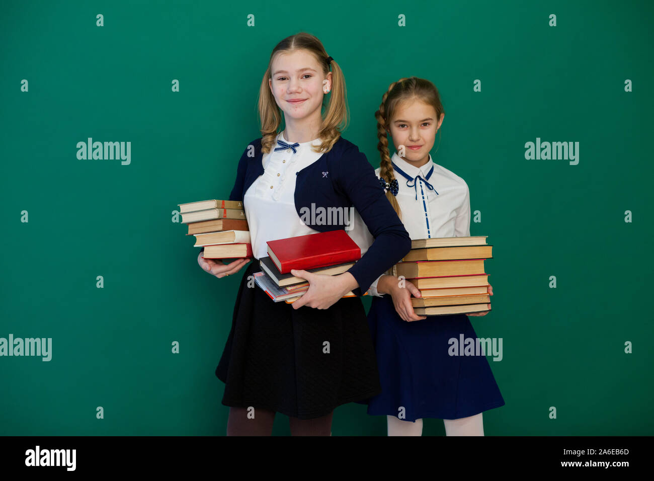 two girls keep a lot of books at school Stock Photo - Alamy