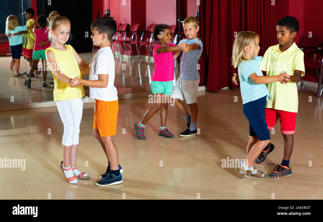 Group of cheerful positive smiling childrens trying dancing with ...