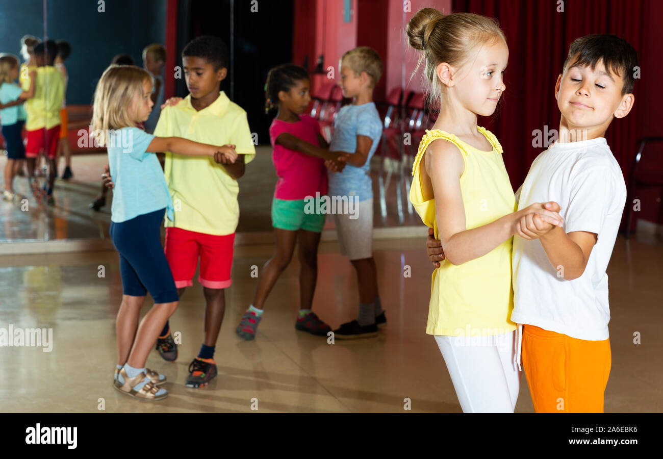 Smiling children primary school trying dancing of partner dance in ...