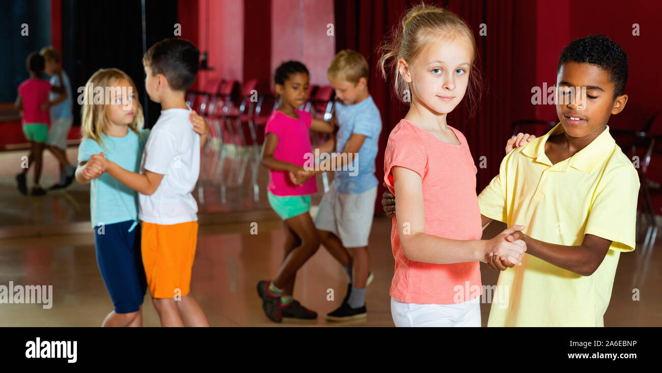 Group of glad smiling cheerful positive childrens trying dancing with ...