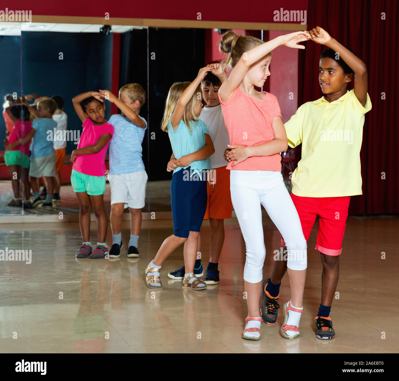Smiling happy children primary school trying dancing salsa dance in ...