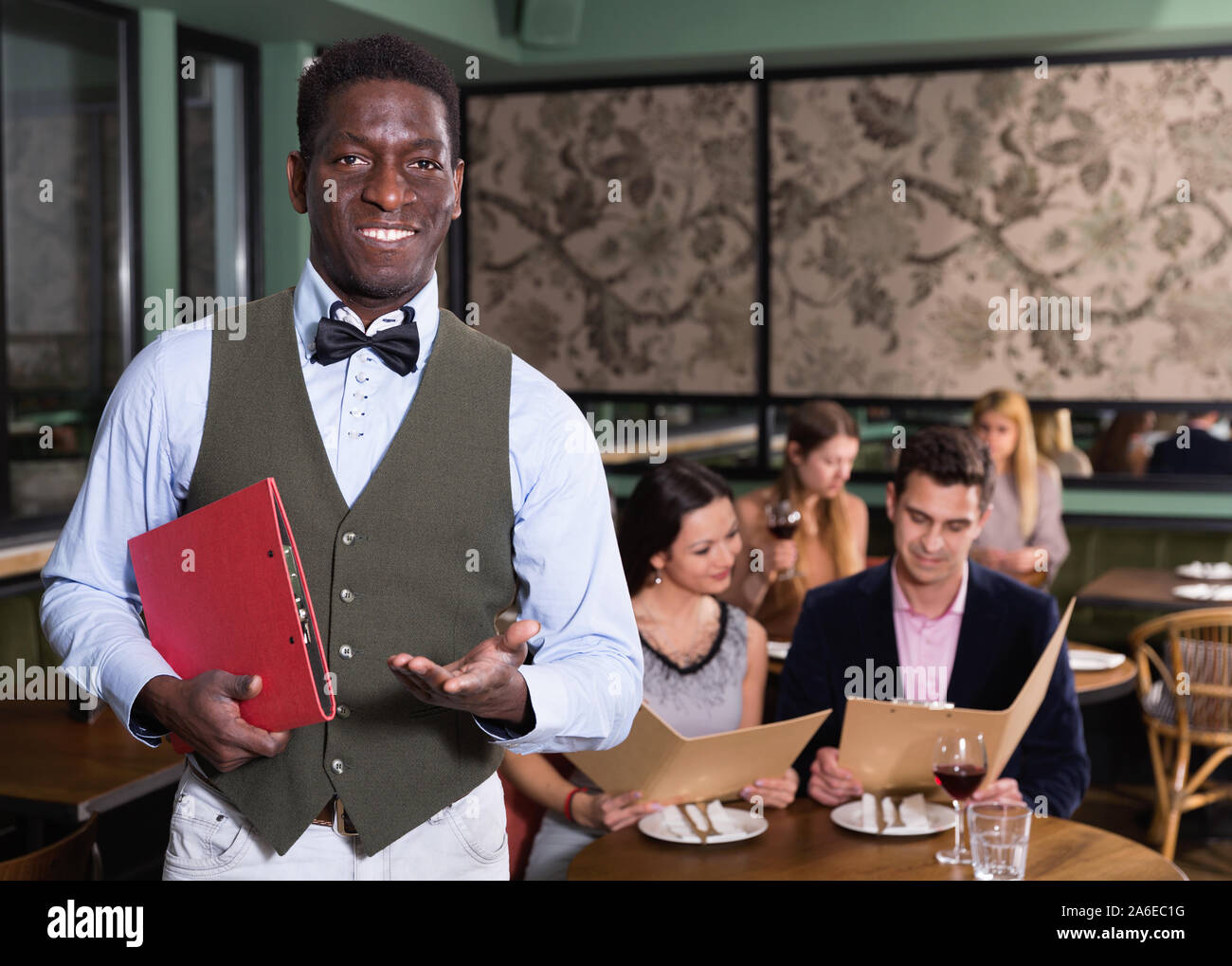 Polite African American cheerful positive male administrator standing ...