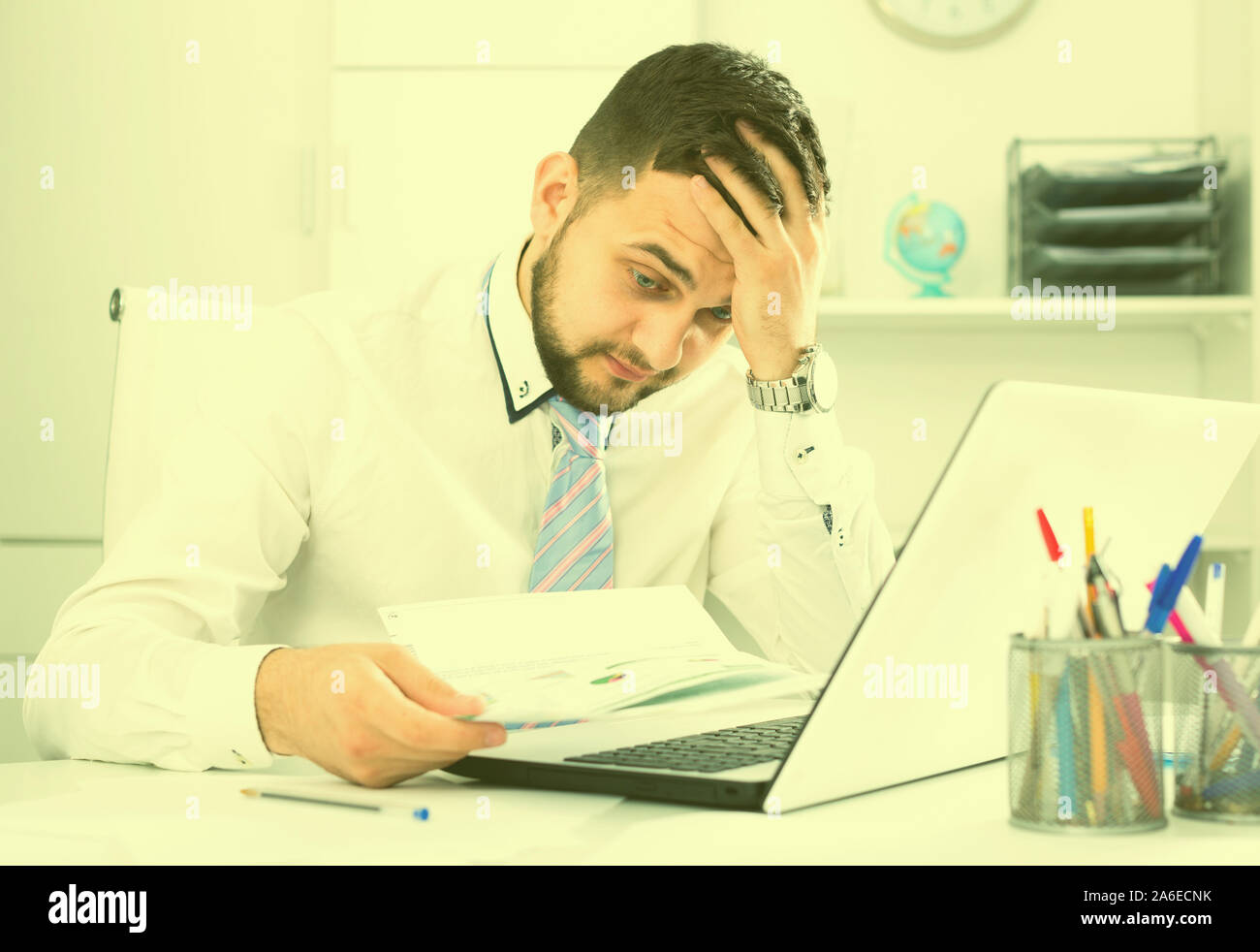 Stressed man worker facing challenge in project in office Stock Photo ...