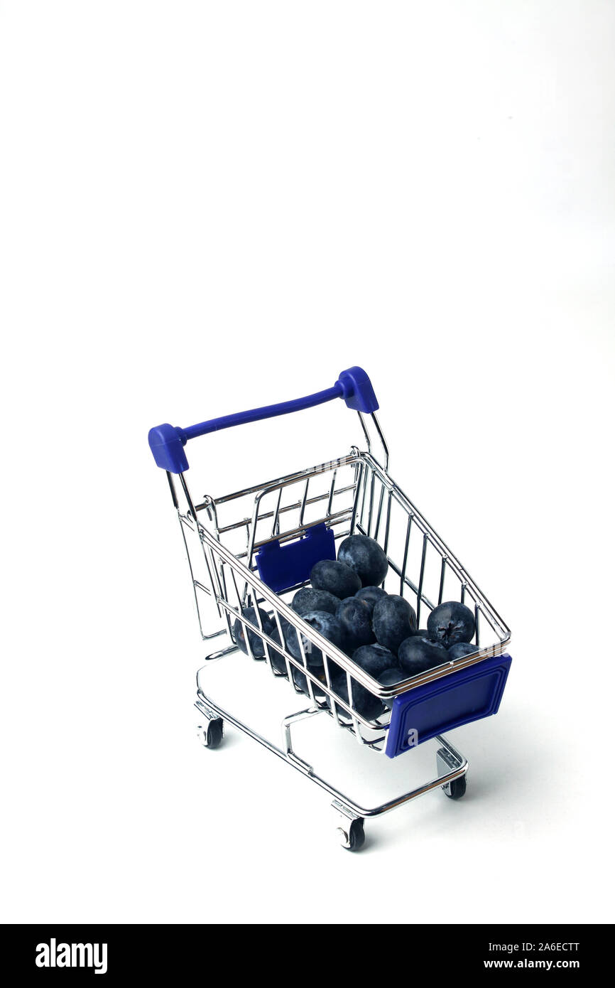 shopping cart with blueberry on white background Stock Photo - Alamy