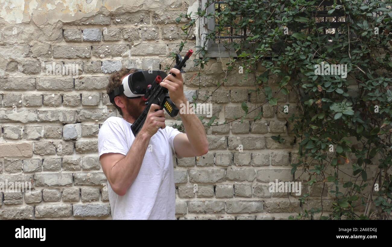 A man plays virtual augmented reality game using head mounted display ...