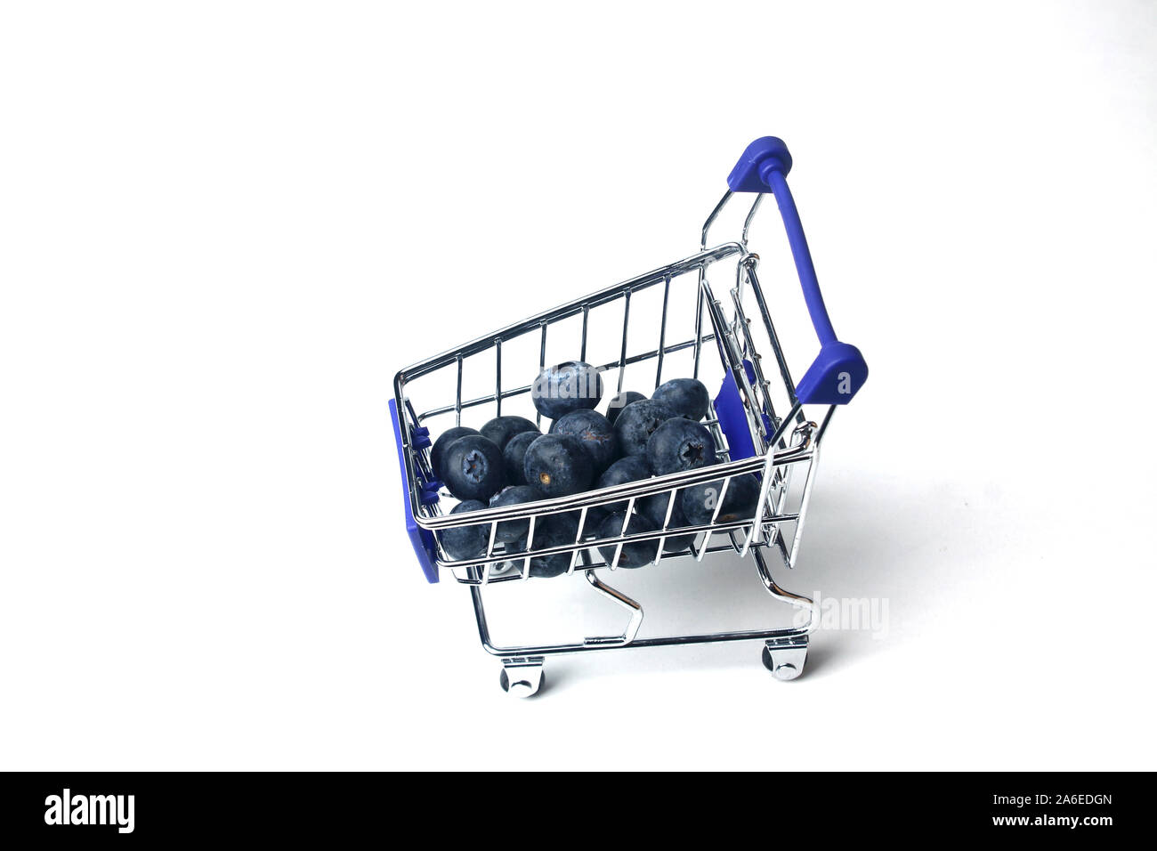 shopping cart with blueberry on white background Stock Photo - Alamy