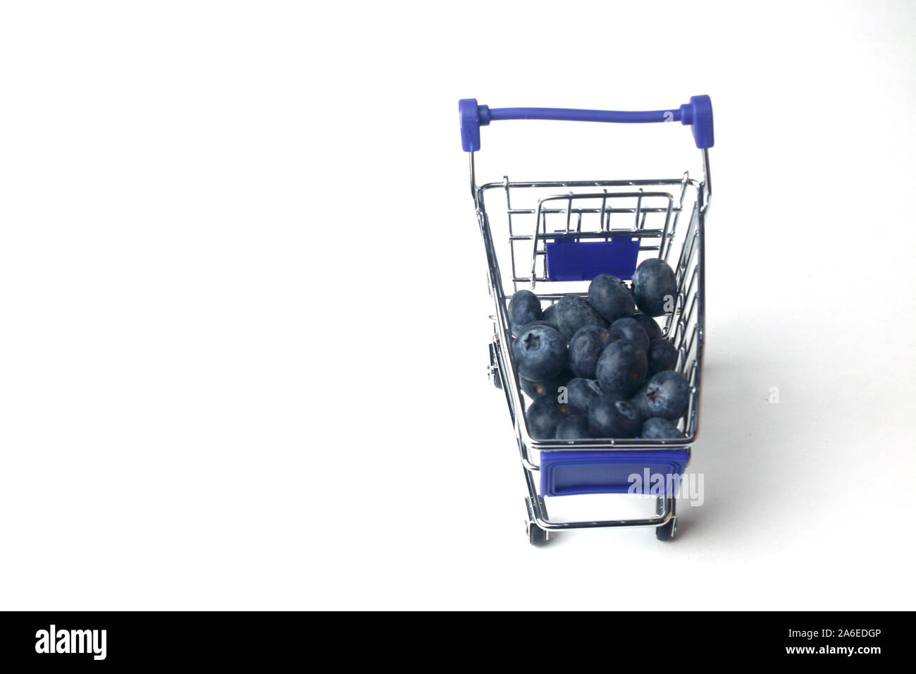 shopping cart with blueberry on white background Stock Photo - Alamy