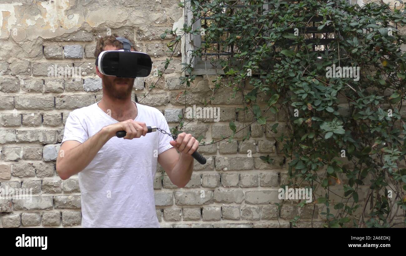 A man plays virtual augmented reality game using head mounted display ...