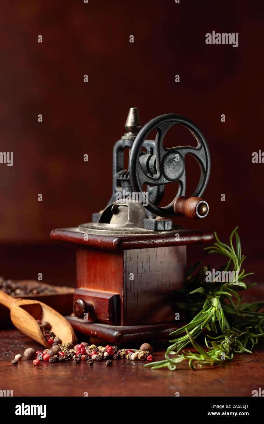 Vintage pepper mill with various peppers and spices. Old pepper mill ...