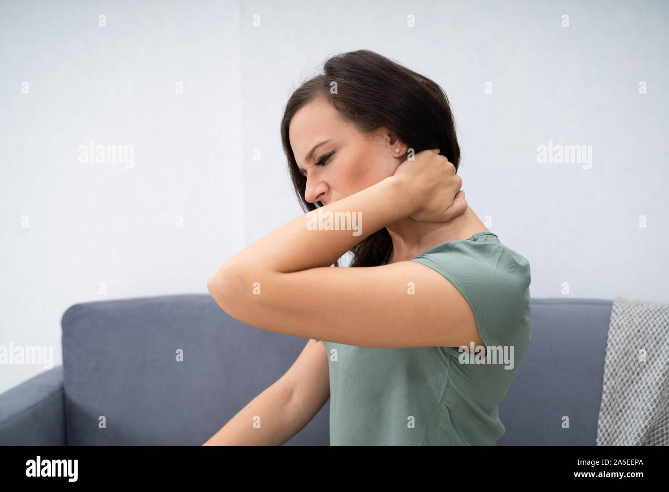 Woman Having Neck Pain Sitting At Home Stock Photo - Alamy