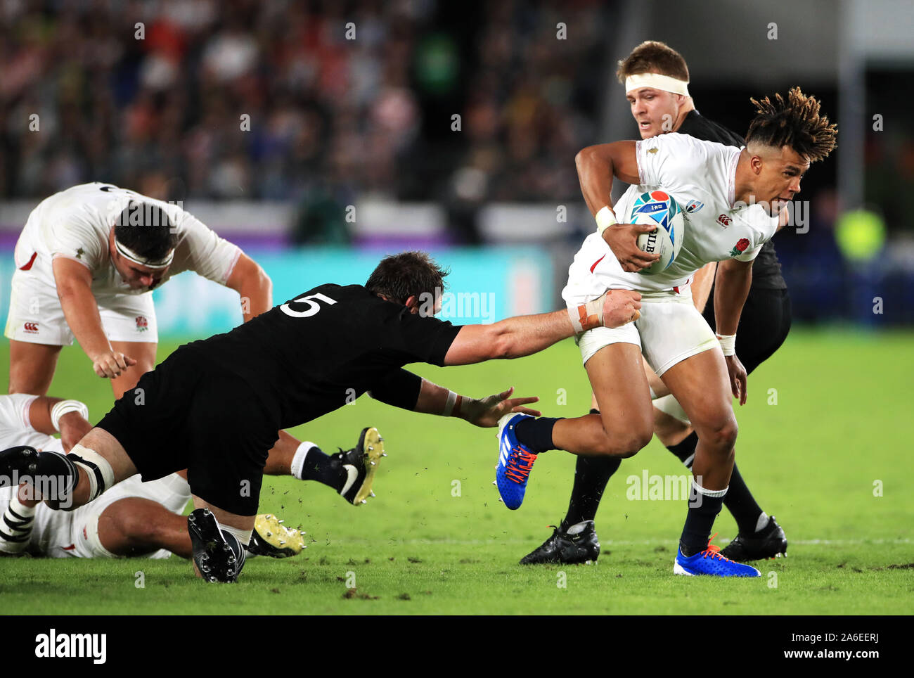 England's Anthony Watson is tackled by New Zealand's Sam Whitelock ...