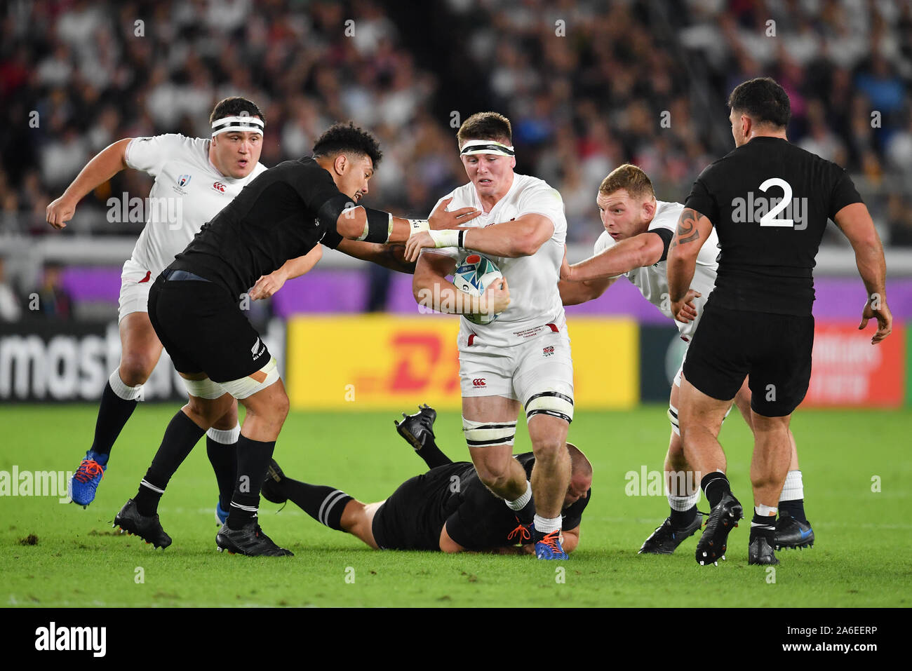 England's Tom Curry evades the tackle of New Zealand's Ardie Savea ...