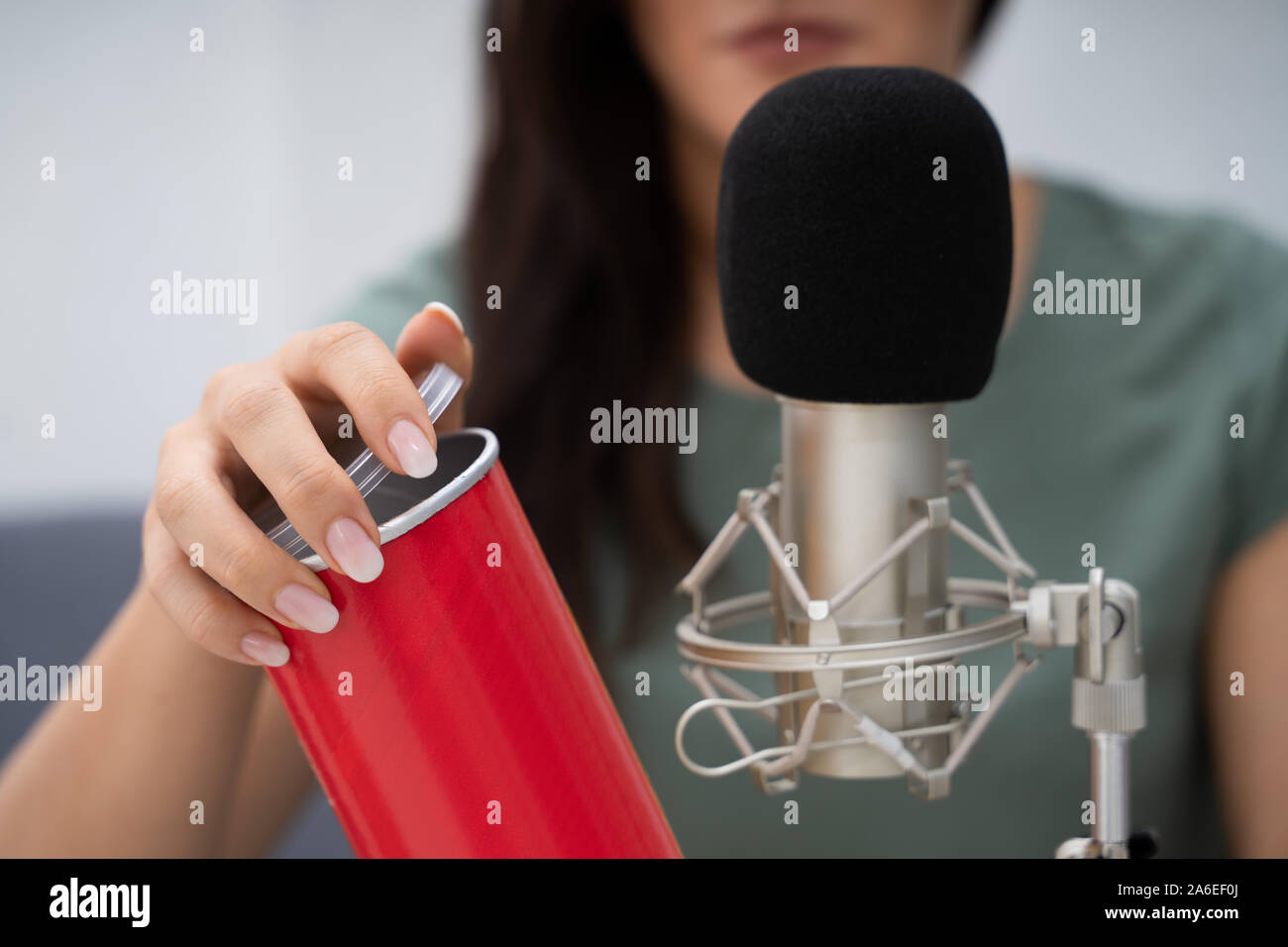 Woman Opening Can On Microphone To Make ASMR Sounds Stock Photo - Alamy