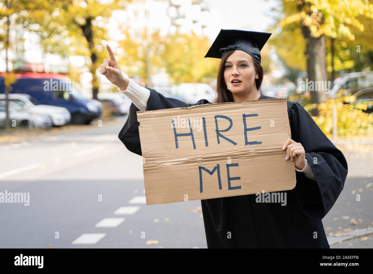 Graduate Student Standing With Hire Me Placard On Street Stock Photo ...