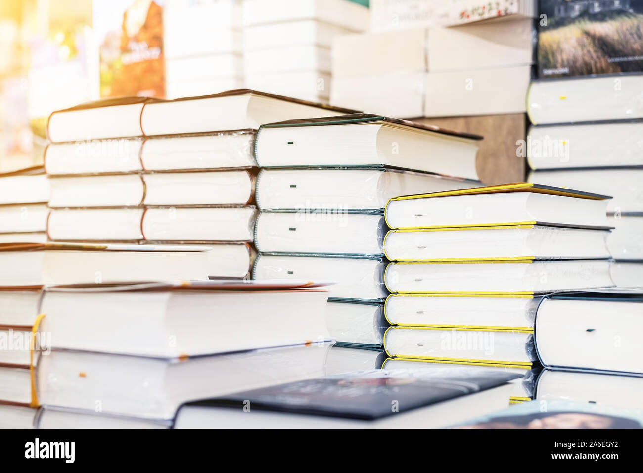 Bookstore shelf with pile of new books with red empty plate. New ...