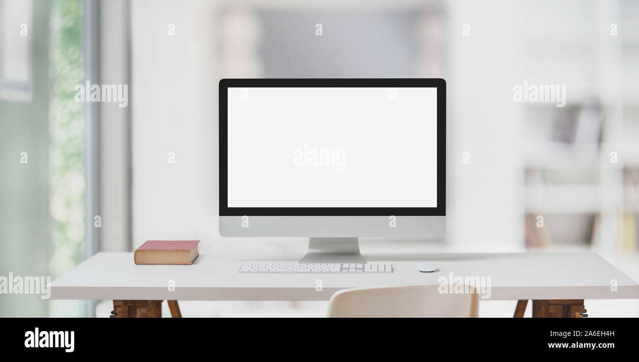 Modern workspace with blank screen desktop computer and decorations on white table and blurred ...