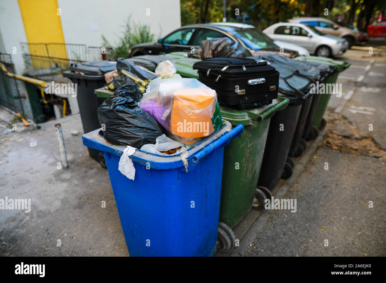 Shallow depth of field image with plastic garbage bins filled with ...