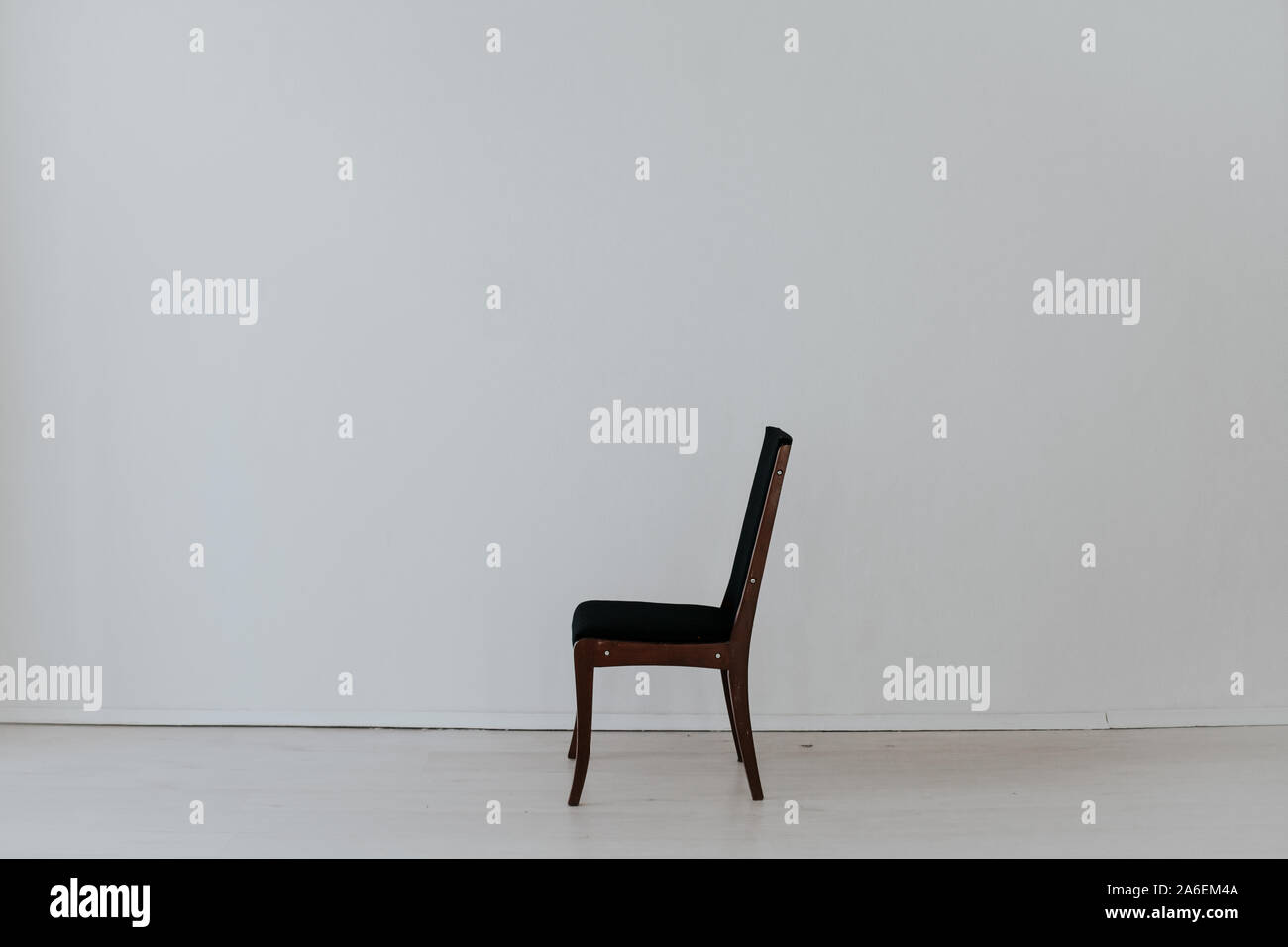black chair in an empty white interior room Stock Photo - Alamy