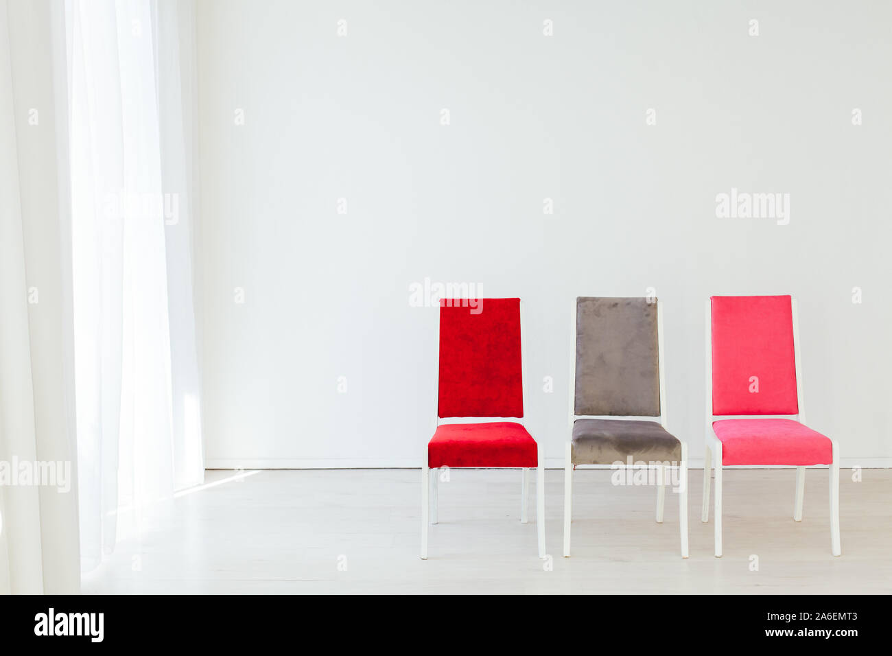 three chairs in an white interior room Stock Photo - Alamy