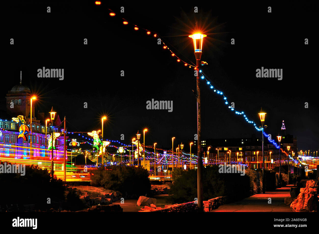 Light trails from road traffic and the illuminated train tram going ...