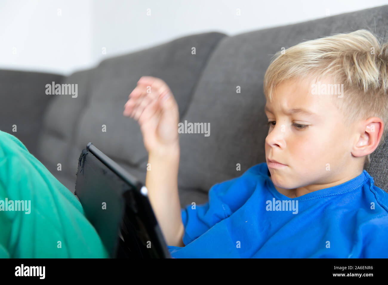 The child spends his free time with modern technology Stock Photo - Alamy