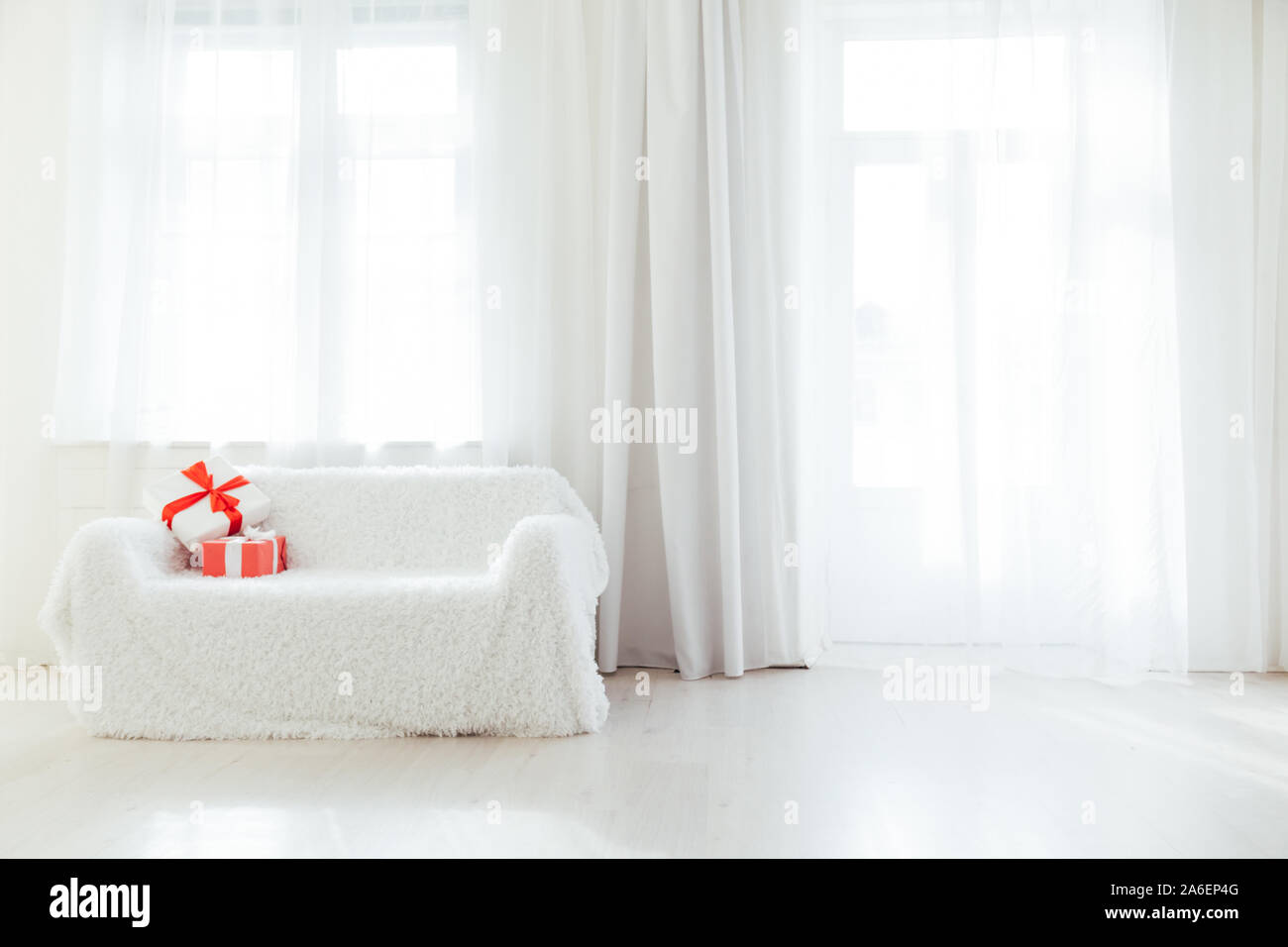 sofa with gifts in the interior of the white room with a window Stock ...