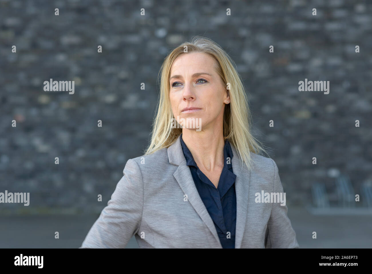 Low angle front bust portrait of confident blond woman looking away ...
