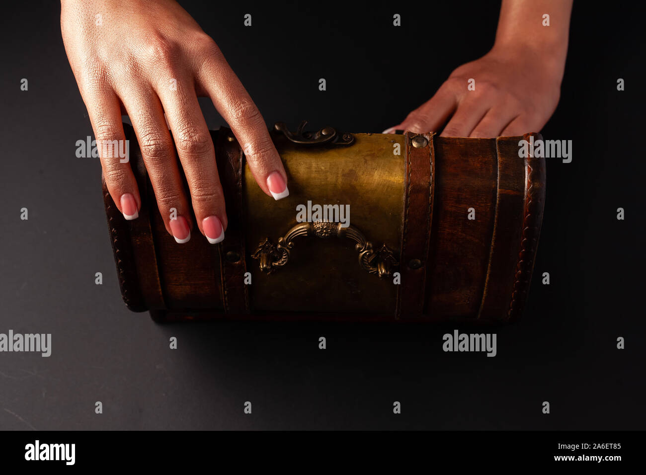 A beautiful female hand opens a chest. Beautiful french manicure Stock ...