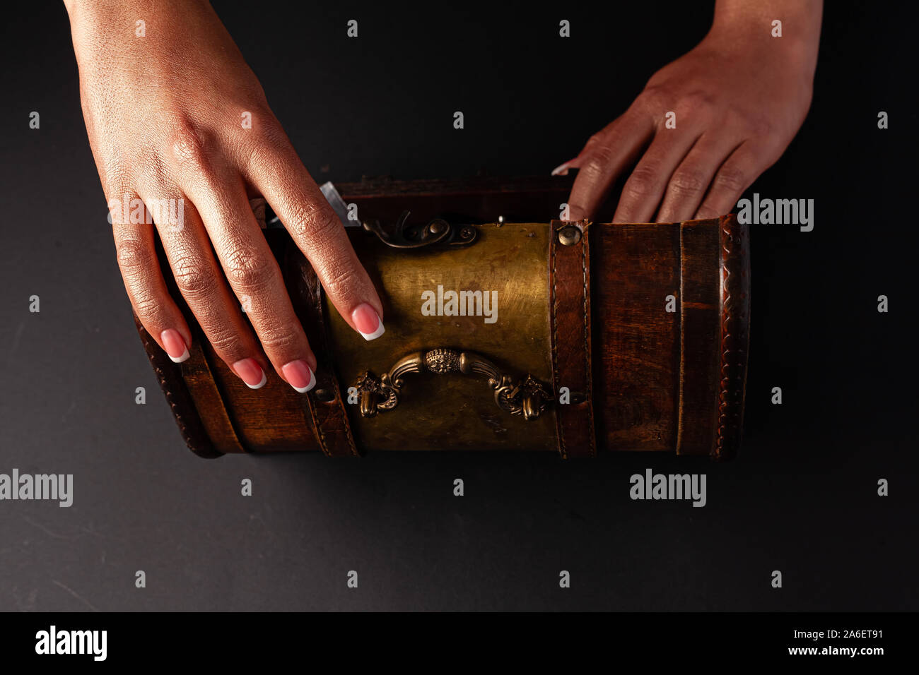 A beautiful female hand opens a chest. Beautiful french manicure Stock ...
