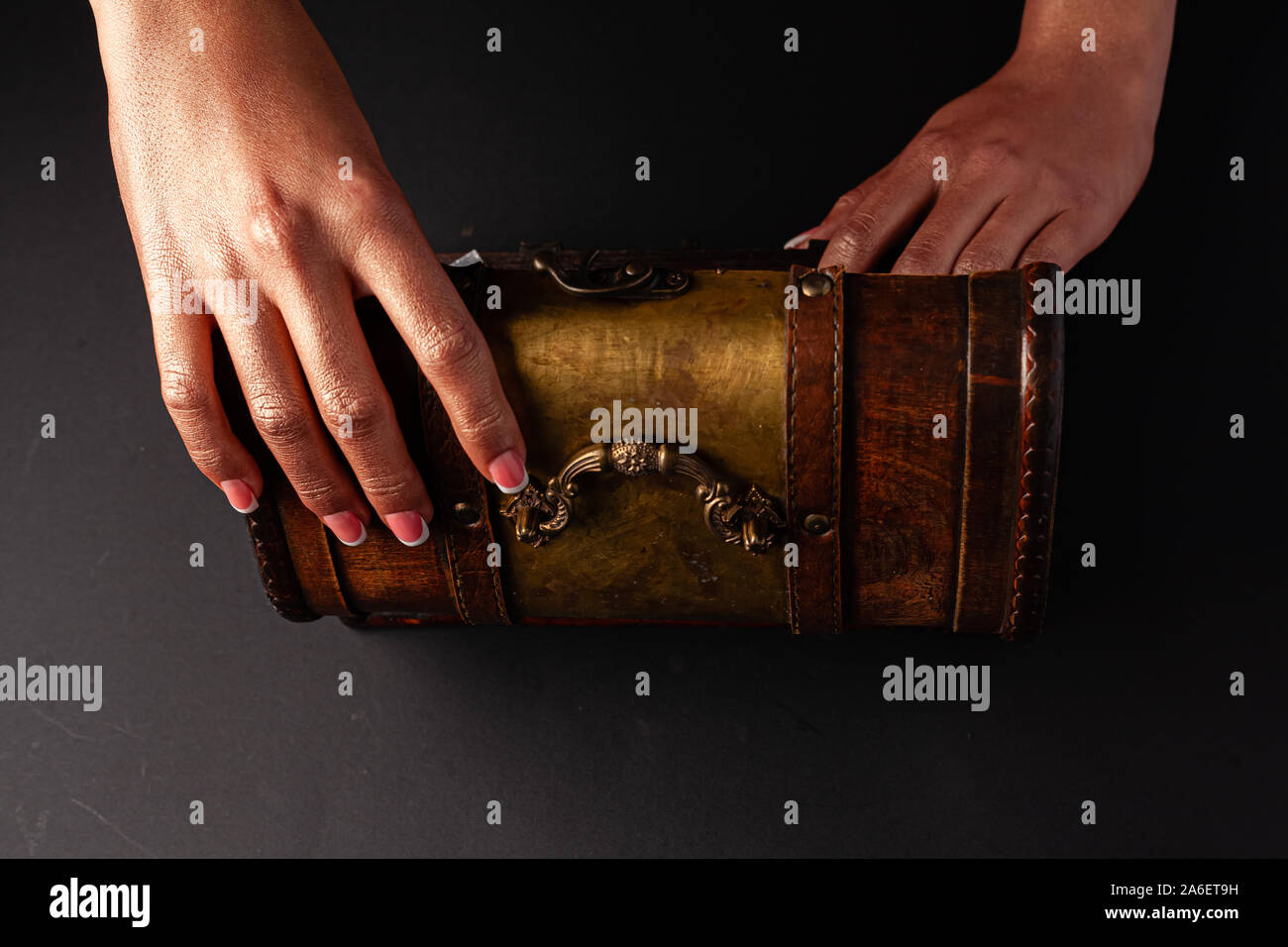 A beautiful female hand opens a chest. Beautiful french manicure Stock ...