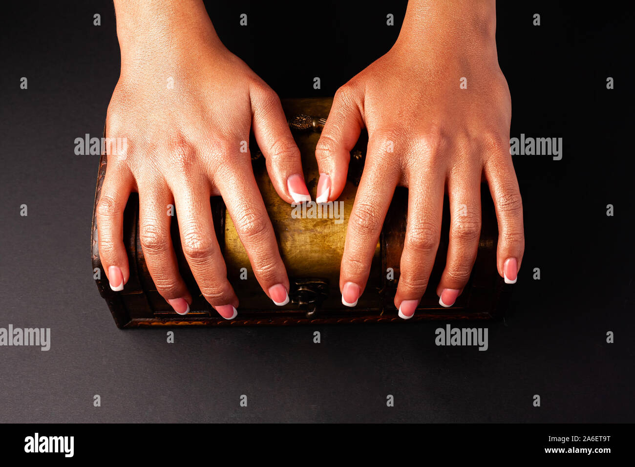 A beautiful female hand opens a chest. Beautiful french manicure Stock ...