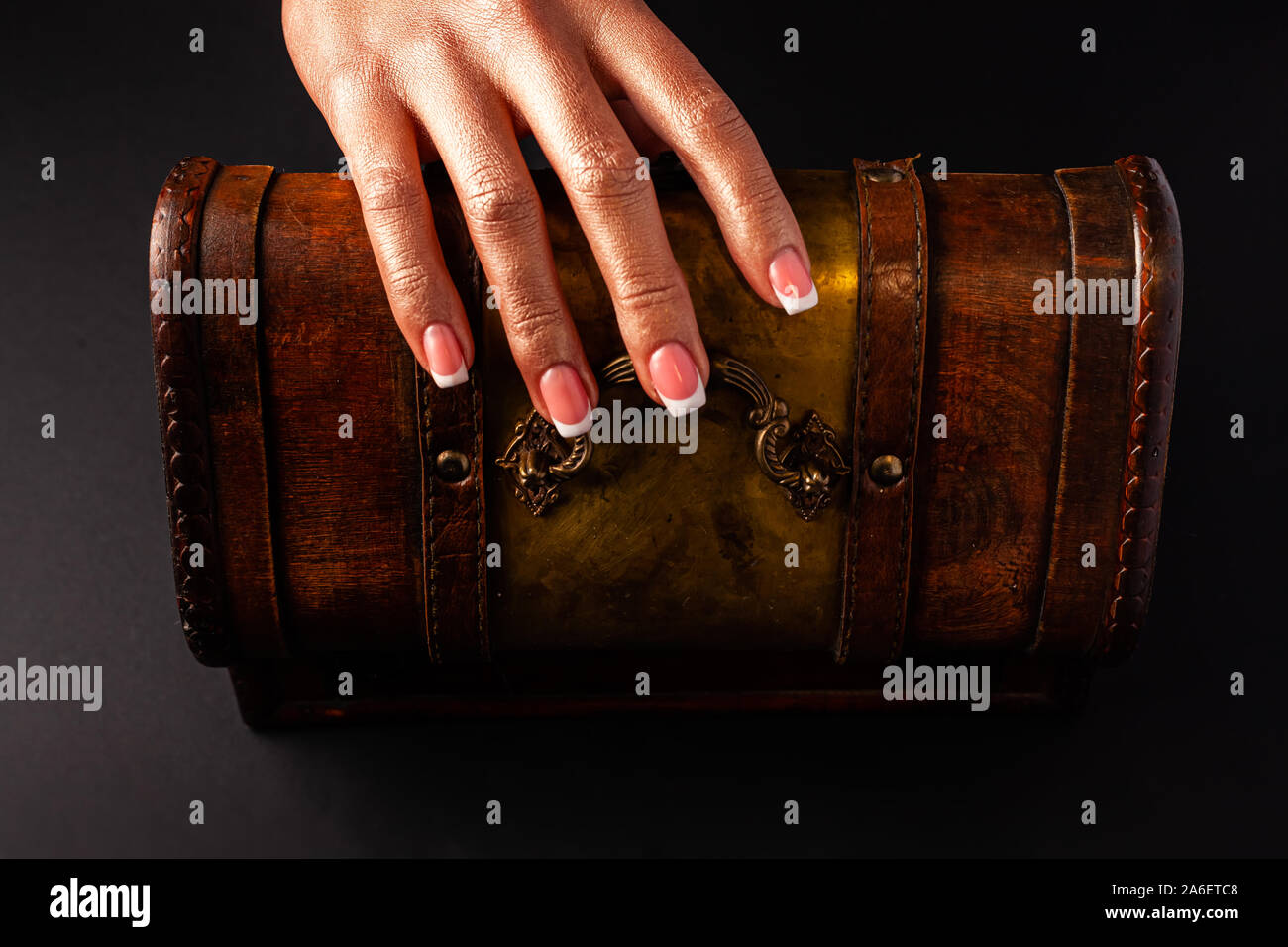 A beautiful female hand opens a chest. Beautiful french manicure Stock ...