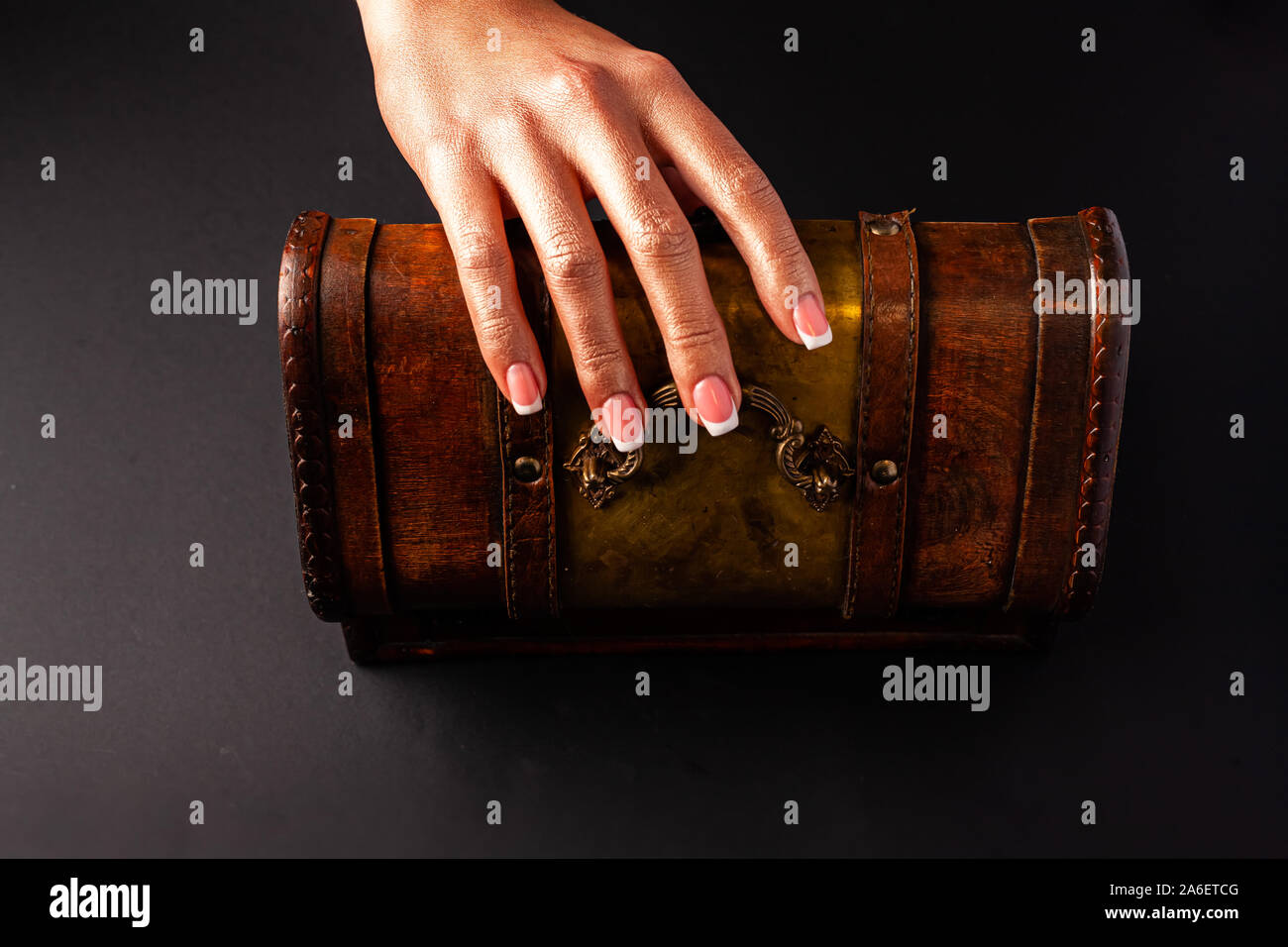 A beautiful female hand opens a chest. Beautiful french manicure Stock ...