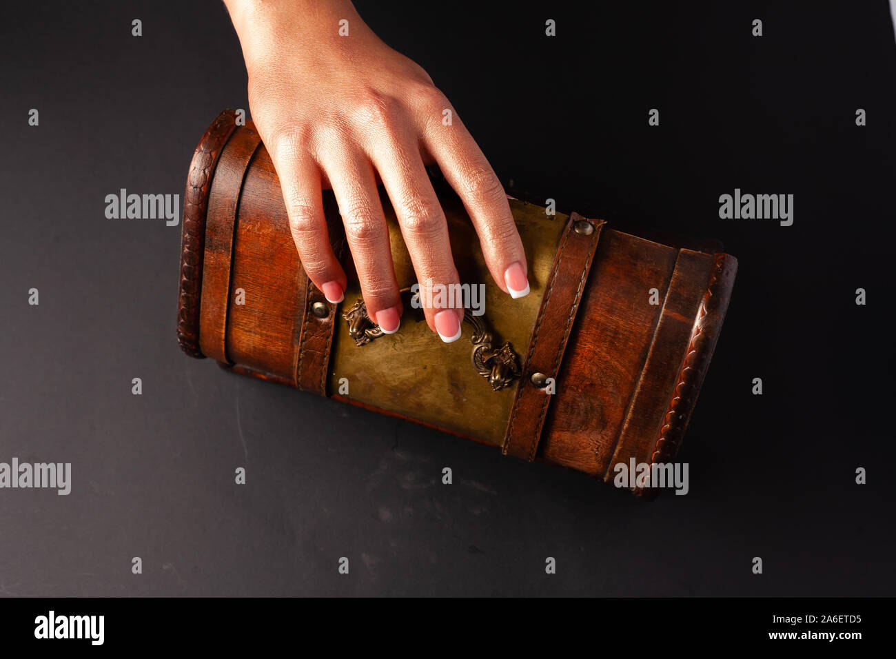 A beautiful female hand opens a chest. Beautiful french manicure Stock ...