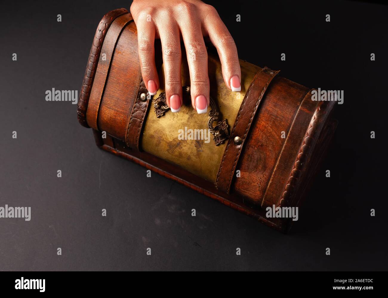 A beautiful female hand opens a chest. Beautiful french manicure Stock ...