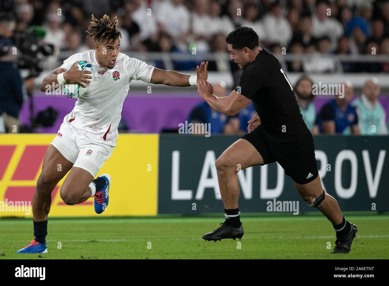 Yokohama, Japan. 26th Oct, 2019. Anthony Watson of England hands off ...