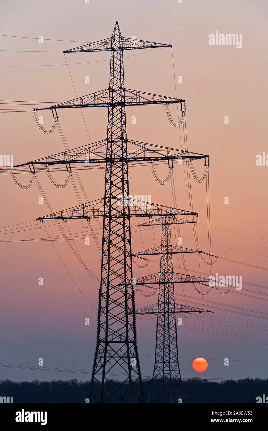 pylons in front of the setting sun Stock Photo - Alamy