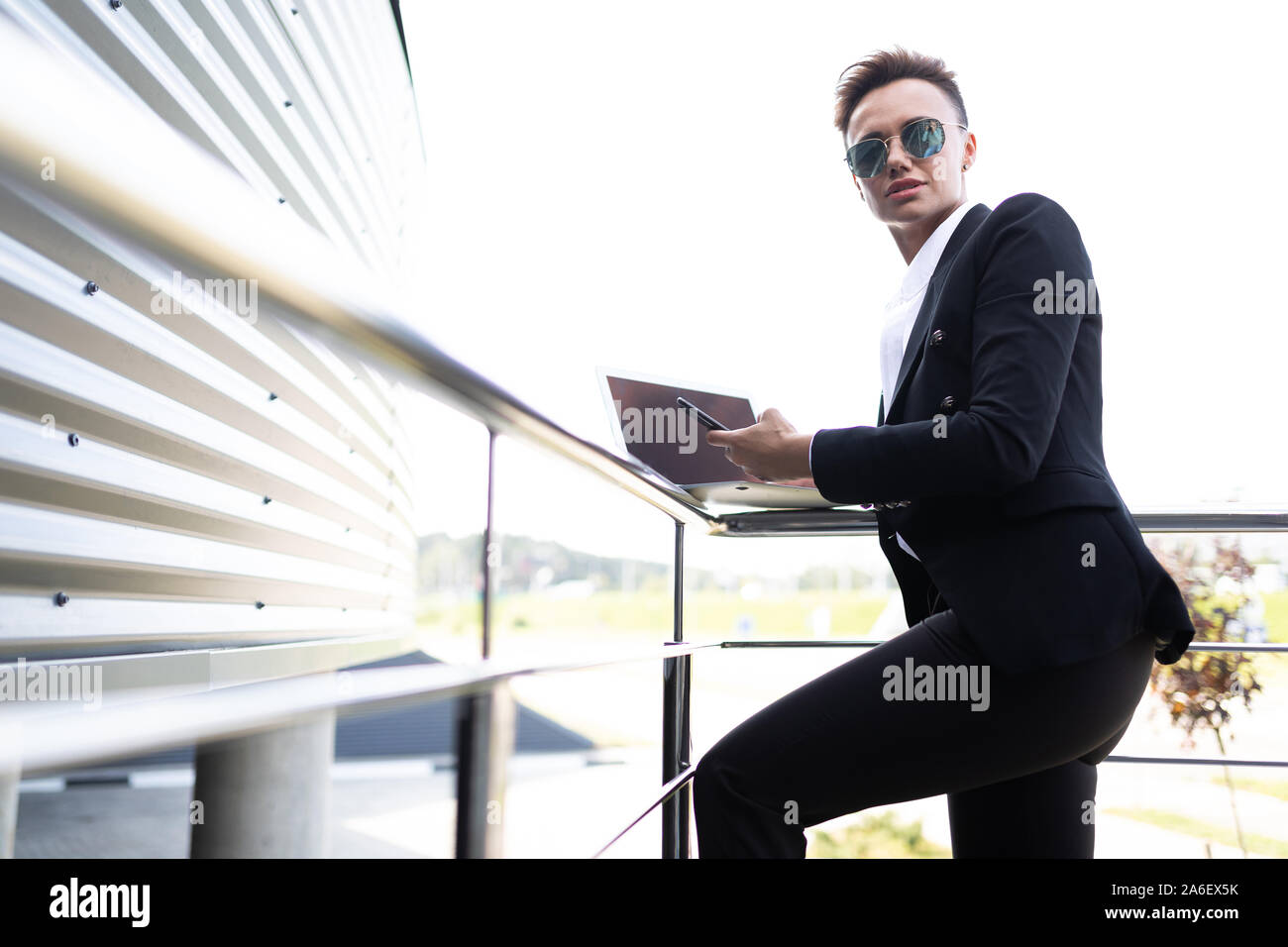 Successful business owner posing of office building Stock Photo - Alamy