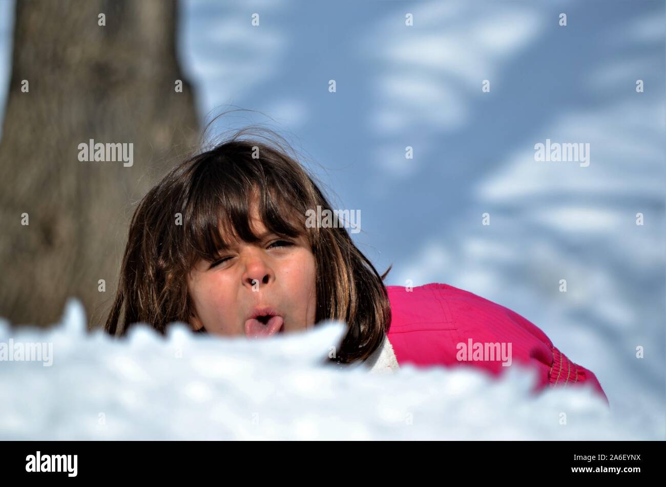 Young girl with happy expressions enjoying snow in winter Stock Photo ...