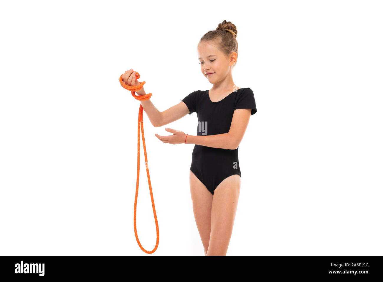 Picture of girl gymnast in black trico in full height keep a jumping ...