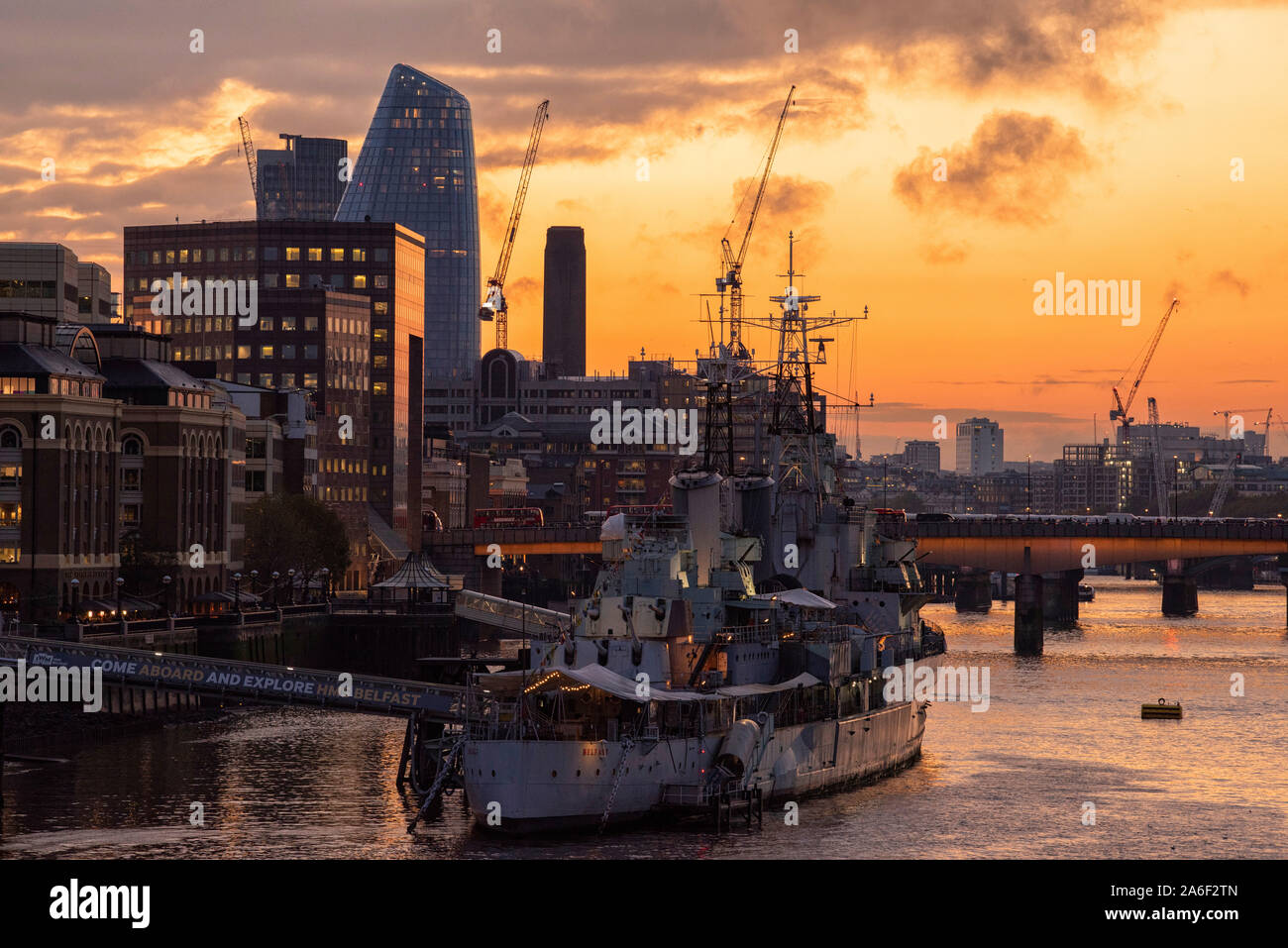 Sunset over the South Bank and HMS Belfast in London, England UK Stock ...