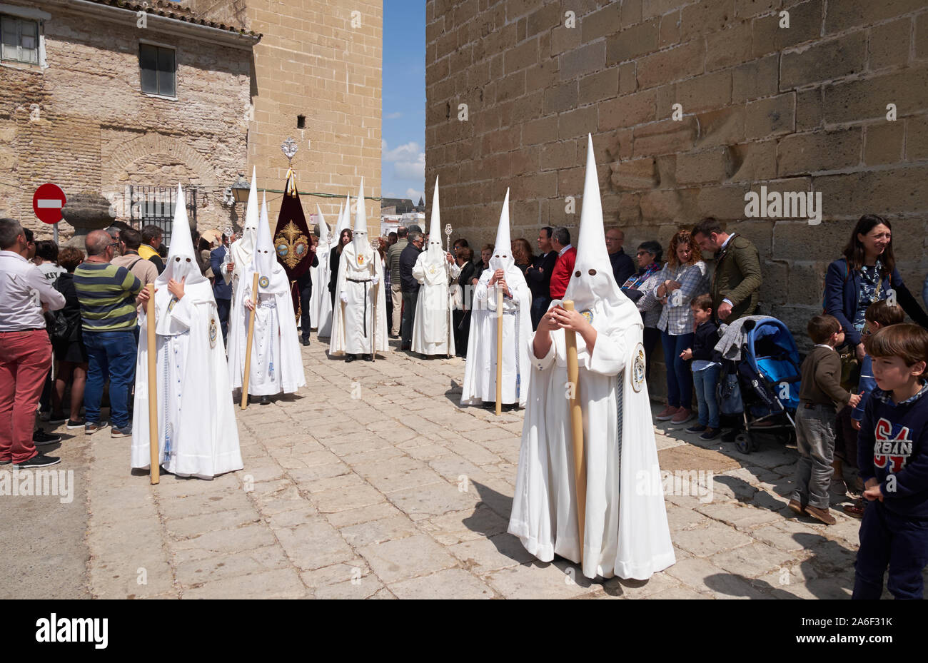 A religious brotherhood wearing penitential robes and conical hoods for ...