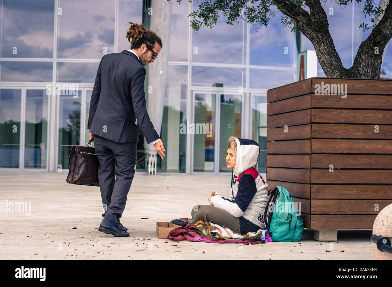 Businessman helps a homeless giving money - business, people and ...