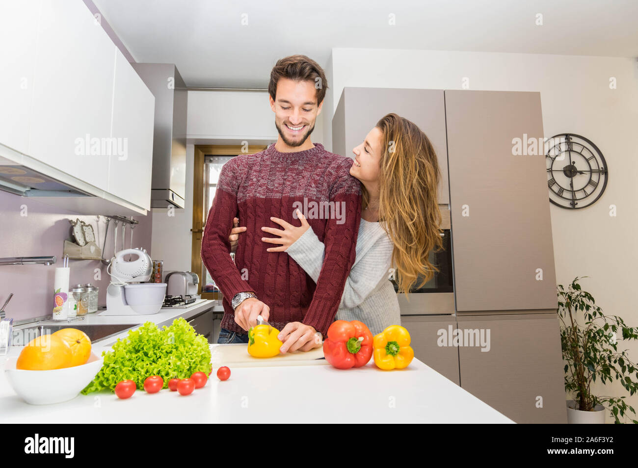 Loving couple cooking together in the kitchen at home Stock Photo - Alamy