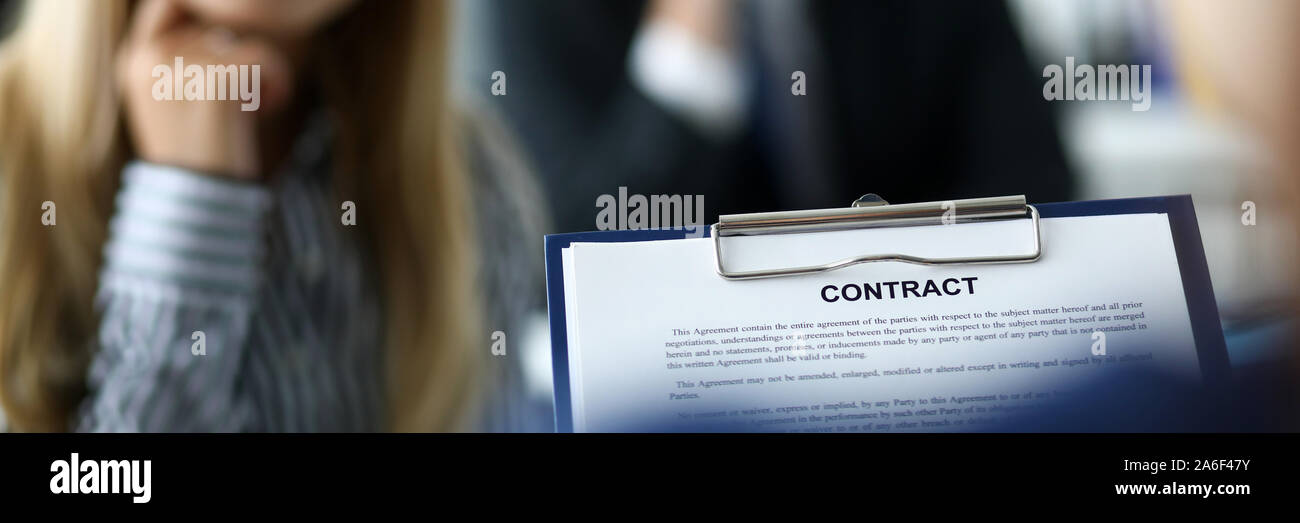 Visitor examining contract application form clipped to pad Stock Photo ...