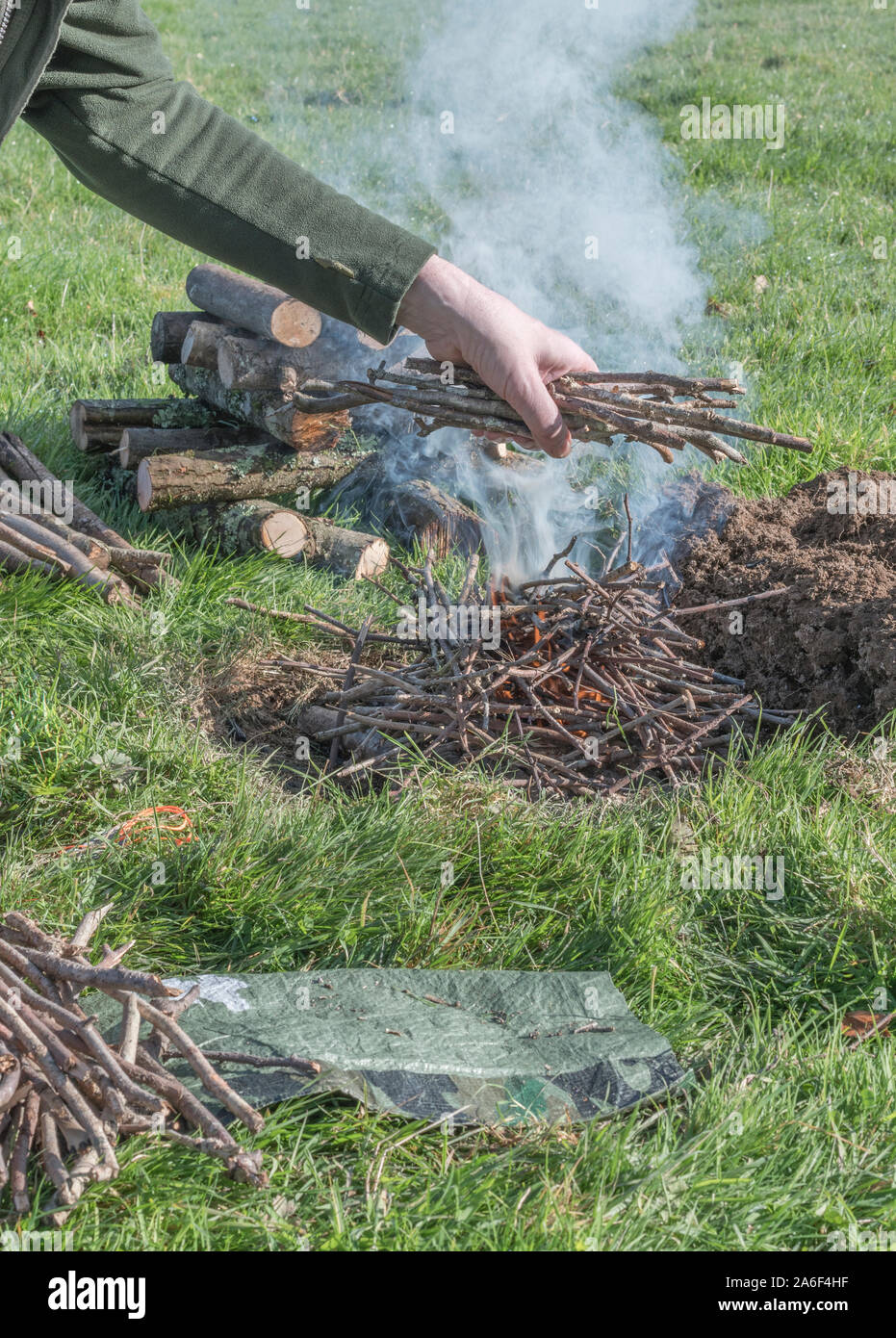 Adding a log to the fire hi-res stock photography and images - Alamy