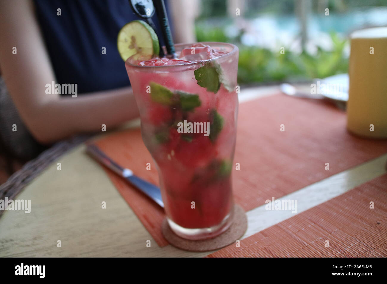A red Mojito style cocktail to drink during lunch on holiday Stock ...